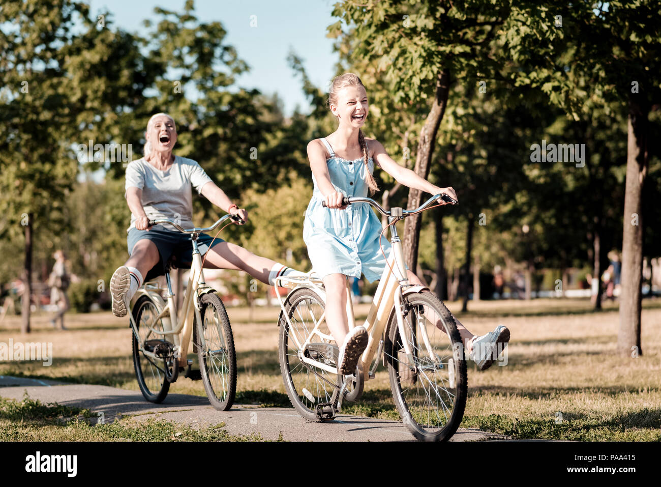 Positive delighted girl raising both legs Stock Photo - Alamy