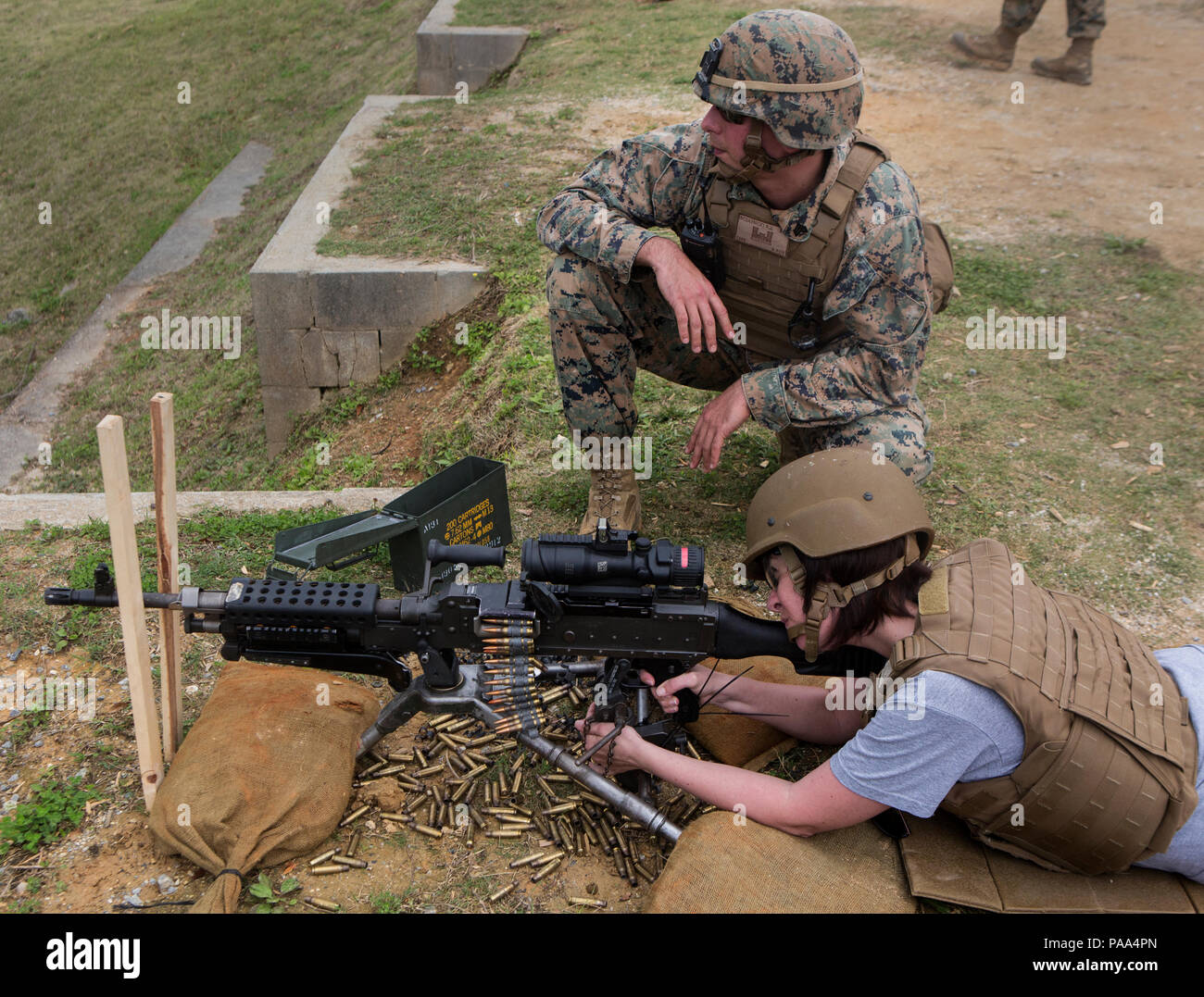 Chief Warrant Officer 3 Milton W. Hoss wife, Gina N. Hoss, fires a M240 ...