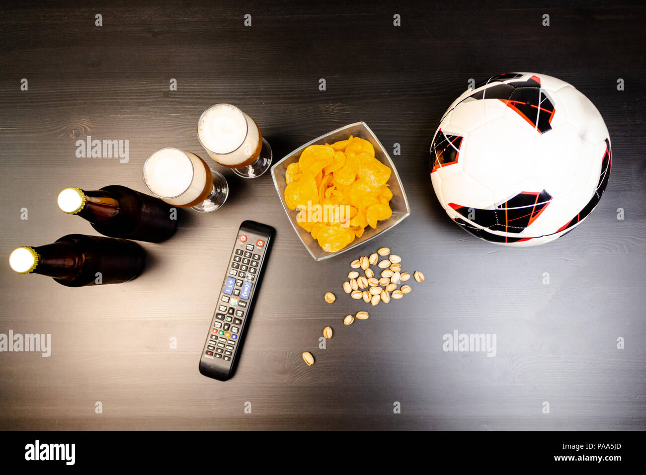 People prepared to watch football on TV with beer. There's beer on the ...