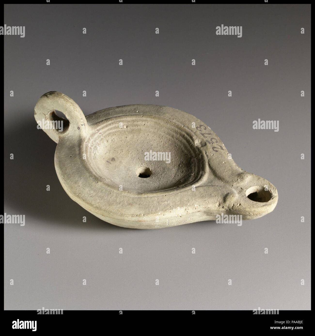 Lamp. Culture: Roman. Dimensions: Overall: 1 3/8 x 3 3/4 in. (3.5 x 9.5 ...