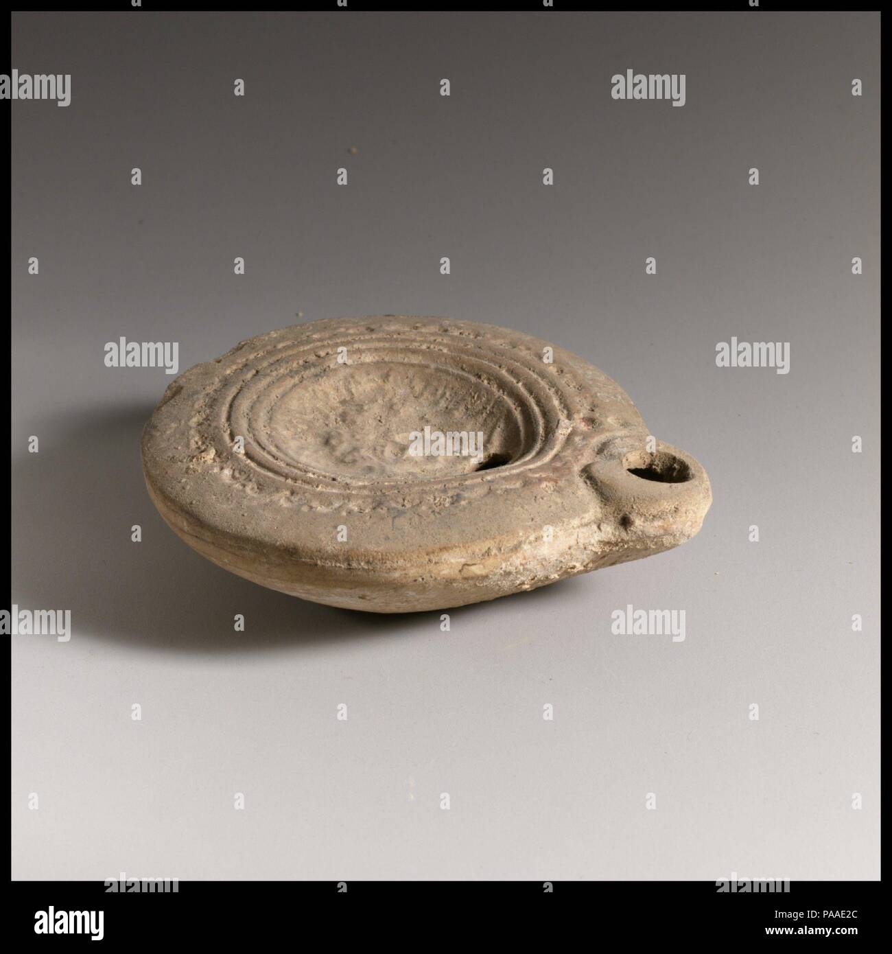 Lamp. Culture: Roman. Dimensions: Length: 3 1/4 in. (8.3 cm) Height: 1 ...
