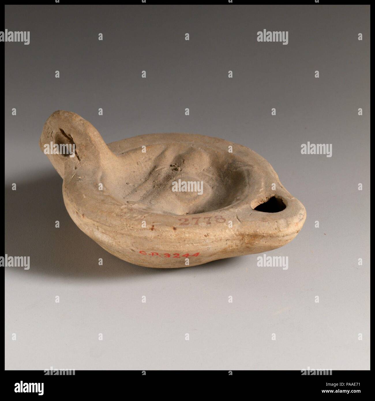 Lamp. Culture: Roman. Dimensions: Length: 3 5/16 in. (8.4 cm) Height: 1 ...