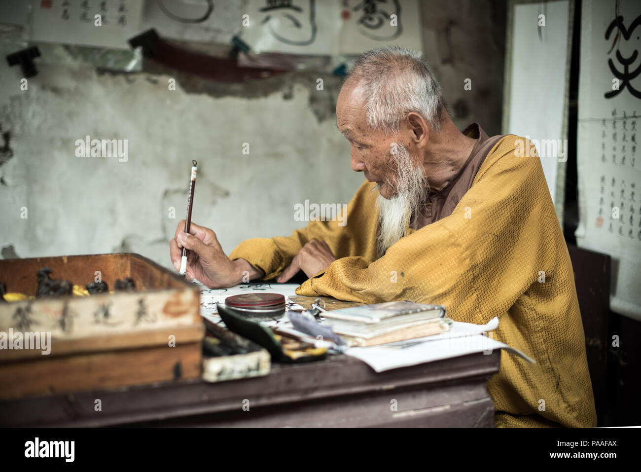 Old Chinese calligraphist and fortune teller with a white beard ...