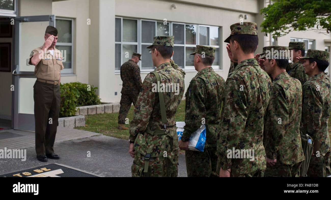 U.S. Marine Sgt. Maj. Jonathan Henry salutes a formation of sergeants ...