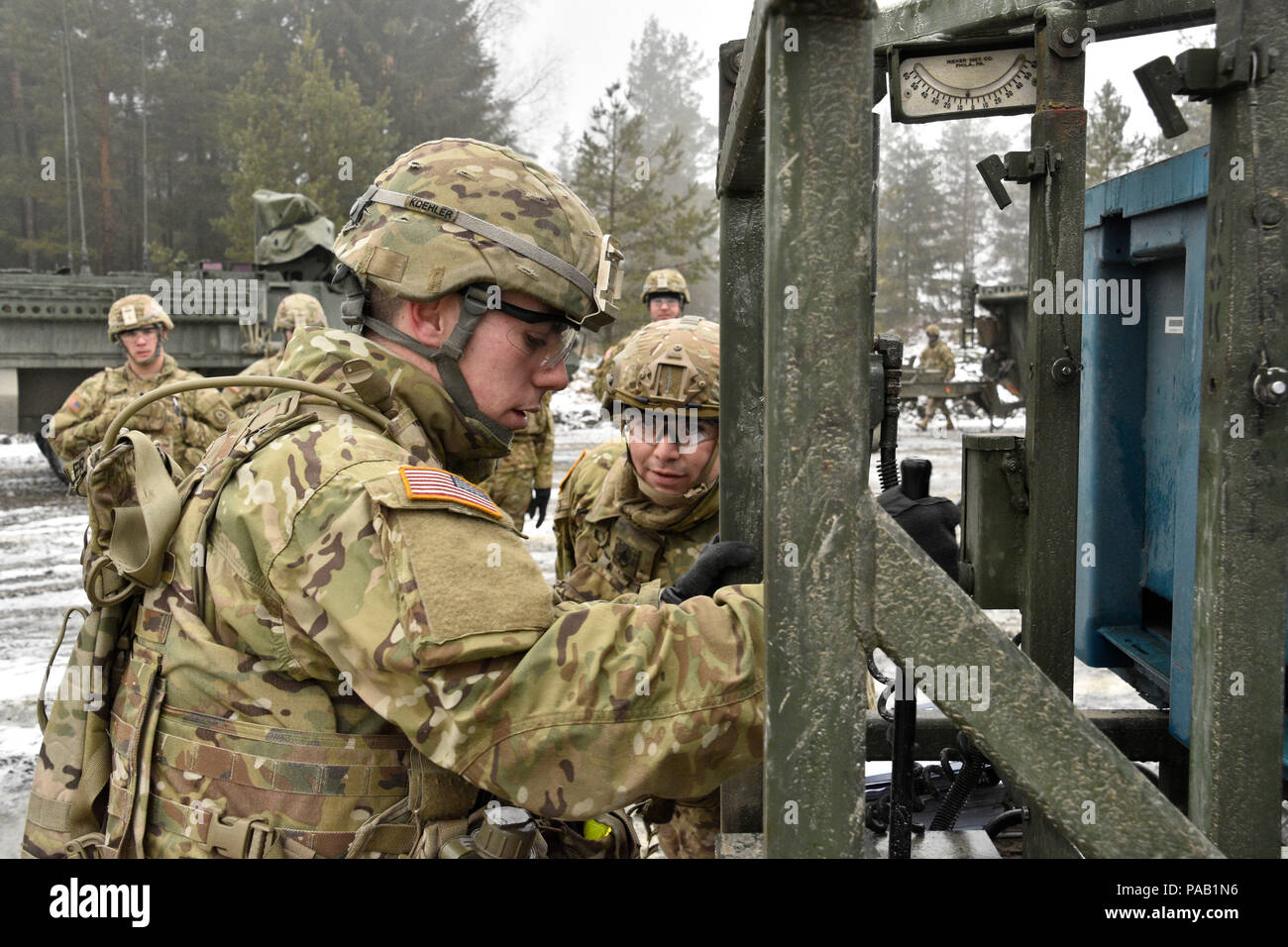 Pfc. Robert Koehler (middle), a combat engineer assigned to 1st Platoon ...