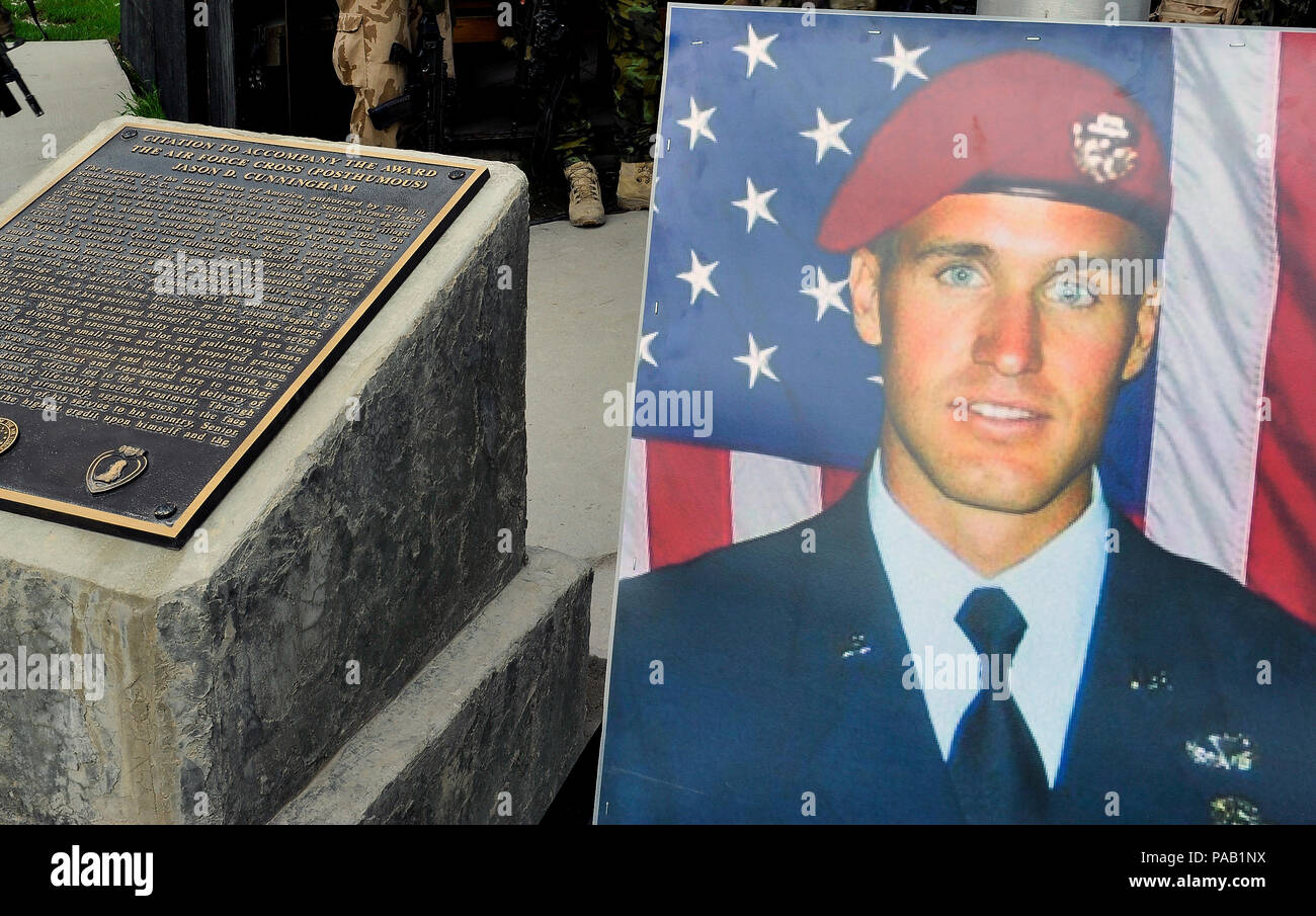 A stone pedestal with an engraved metal plaque and a photograph of ...