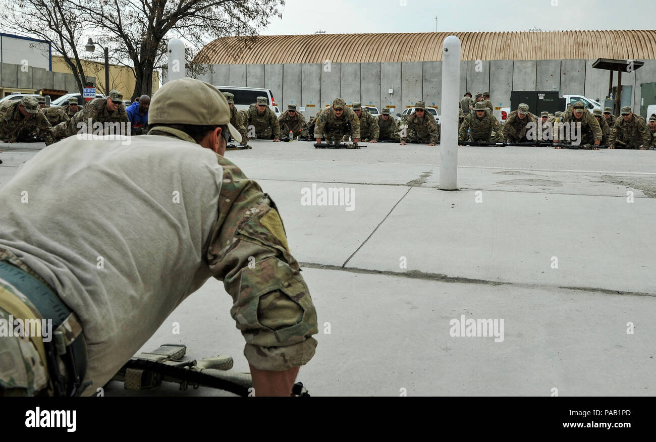 A pararescueman leads traditional push-ups in front of service members ...