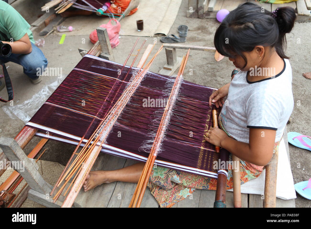 women engaged in traditional weaving at the indonesian island of ...