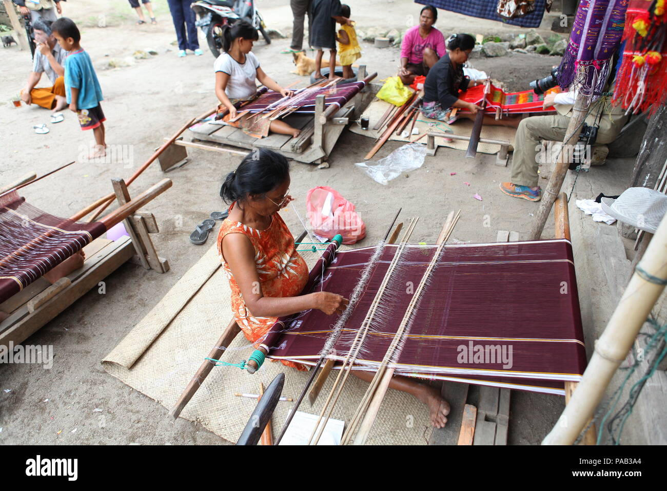 women engaged in traditional weaving at the indonesian island of ...