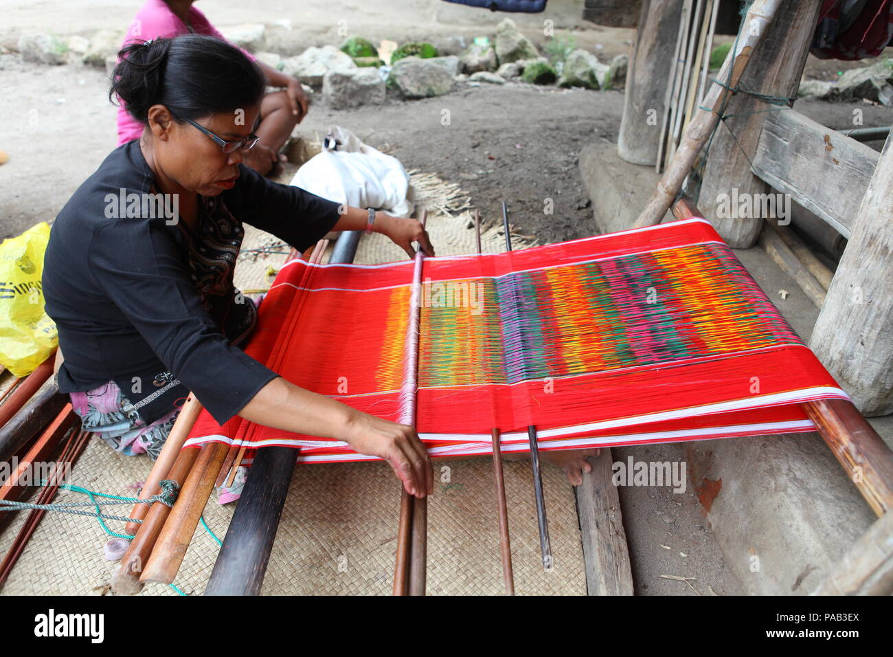 women engaged in traditional weaving at the indonesian island of ...