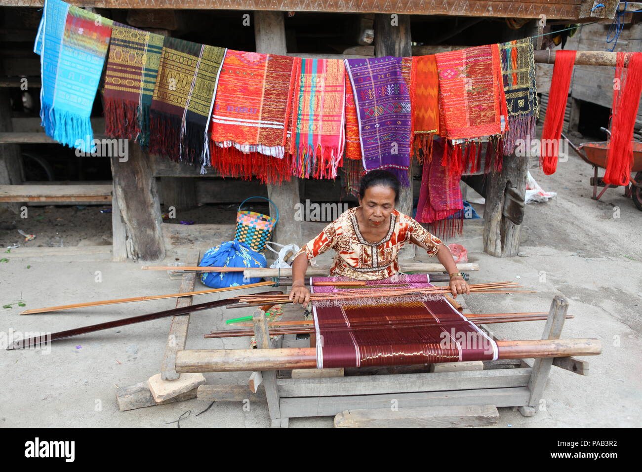 women engaged in traditional weaving at the indonesian island of ...