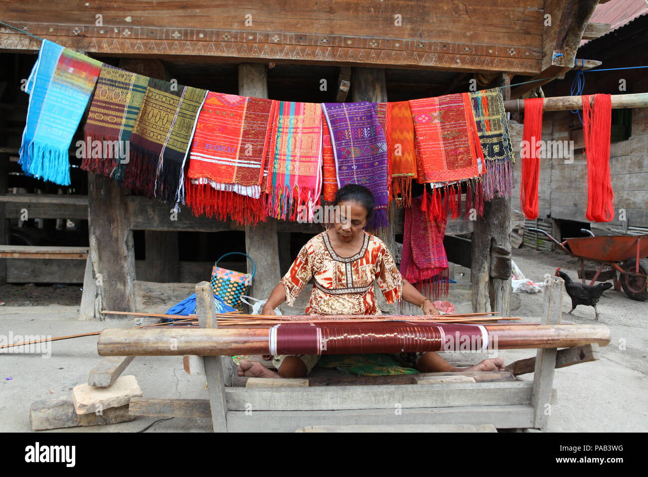 women engaged in traditional weaving at the indonesian island of ...