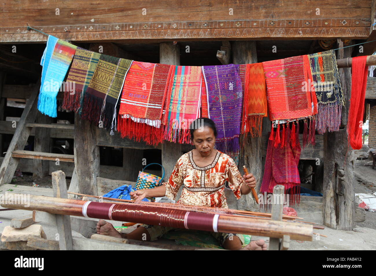 women engaged in traditional weaving at the indonesian island of ...