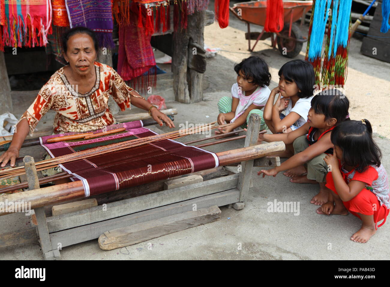 women engaged in traditional weaving at the indonesian island of ...