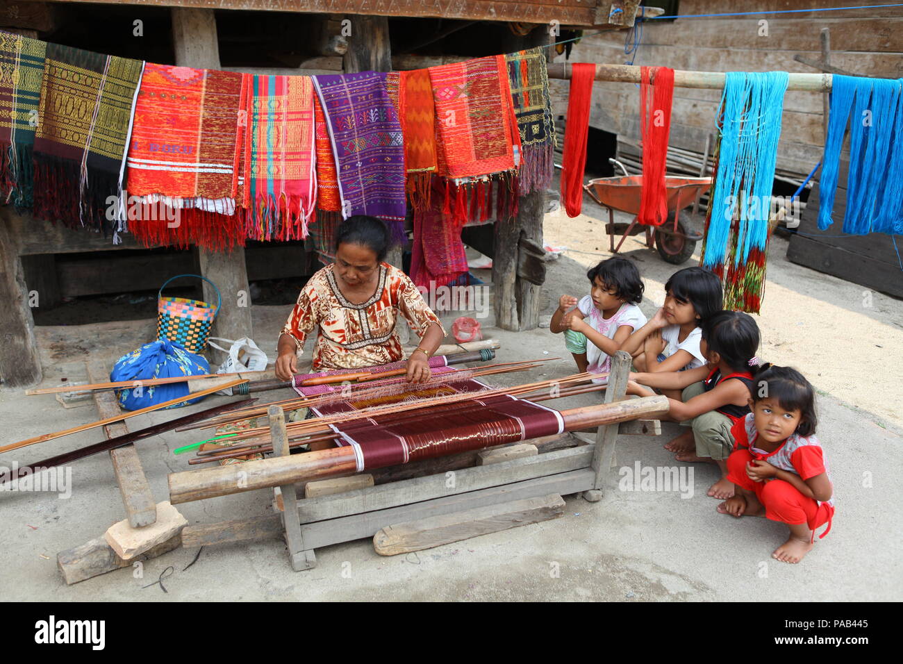 women engaged in traditional weaving at the indonesian island of ...