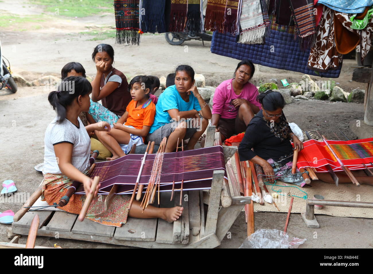 women engaged in traditional weaving at the indonesian island of ...