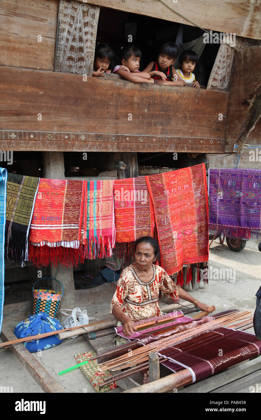 women engaged in traditional weaving at the indonesian island of ...