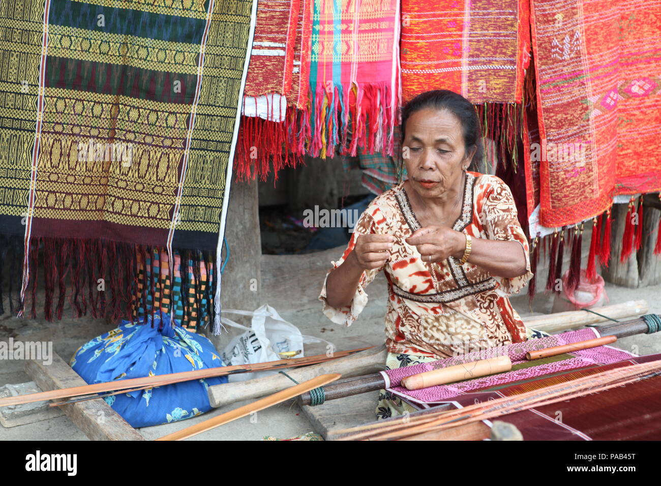women engaged in traditional weaving at the indonesian island of ...