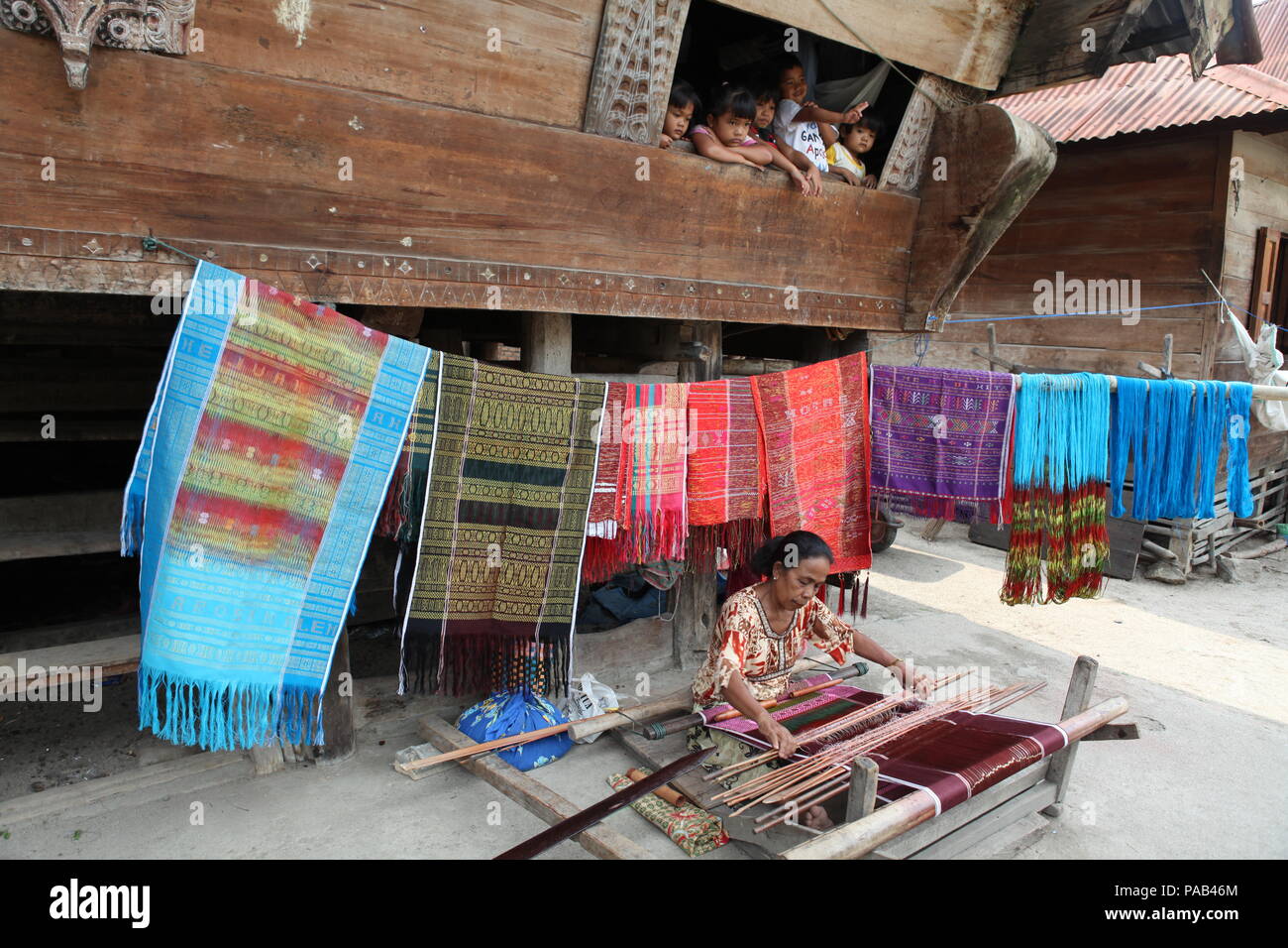 women engaged in traditional weaving at the indonesian island of ...