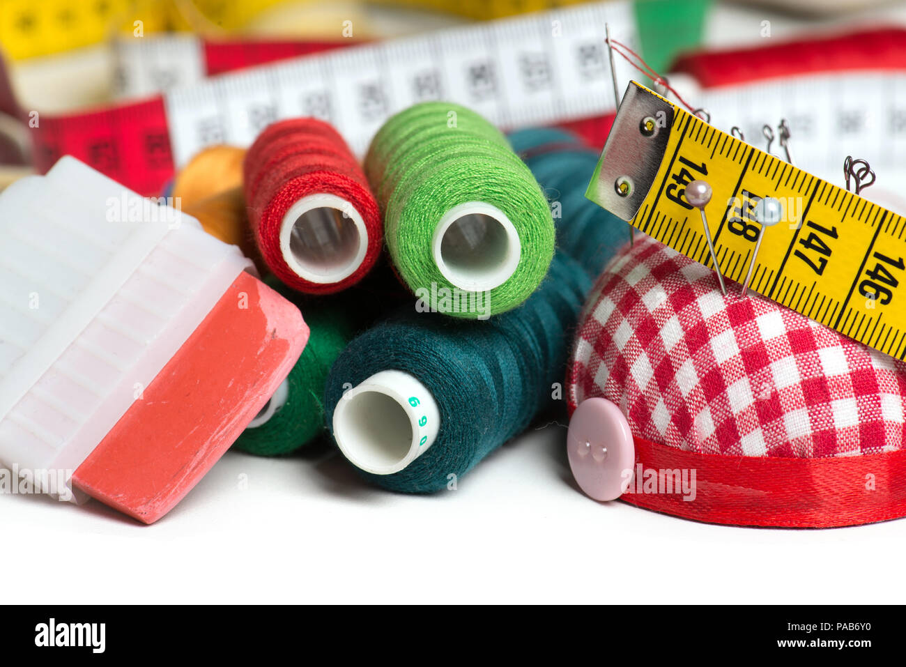 Sewing background with color threads and meter Stock Photo - Alamy