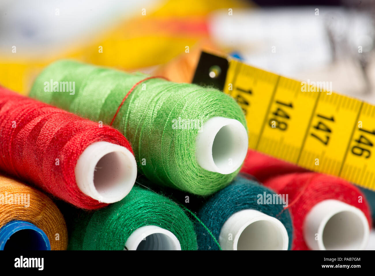 Sewing background with color threads and meter Stock Photo - Alamy
