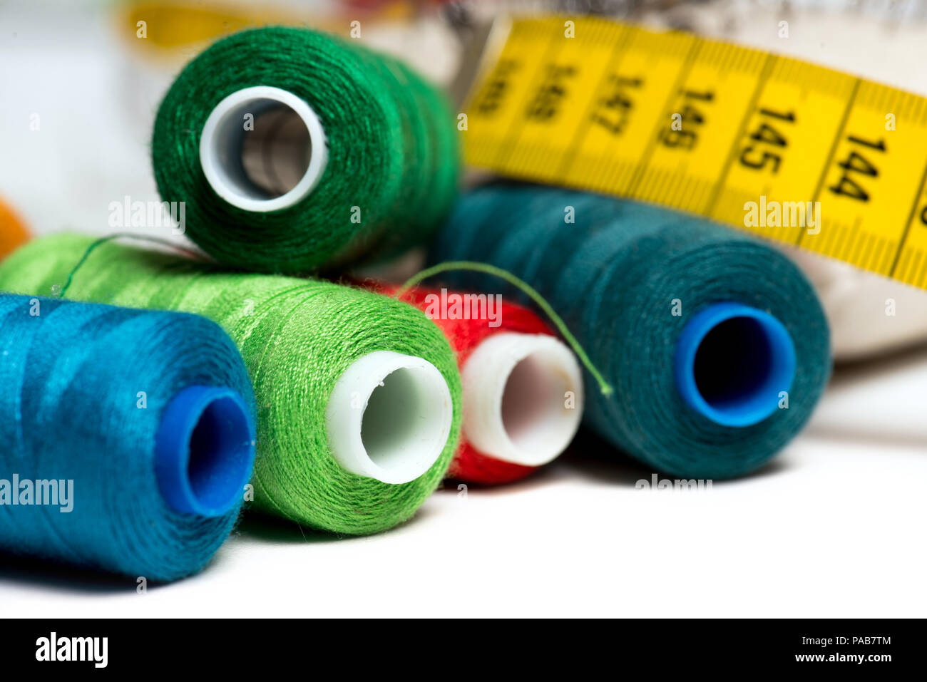 Sewing background with color threads and meter Stock Photo - Alamy