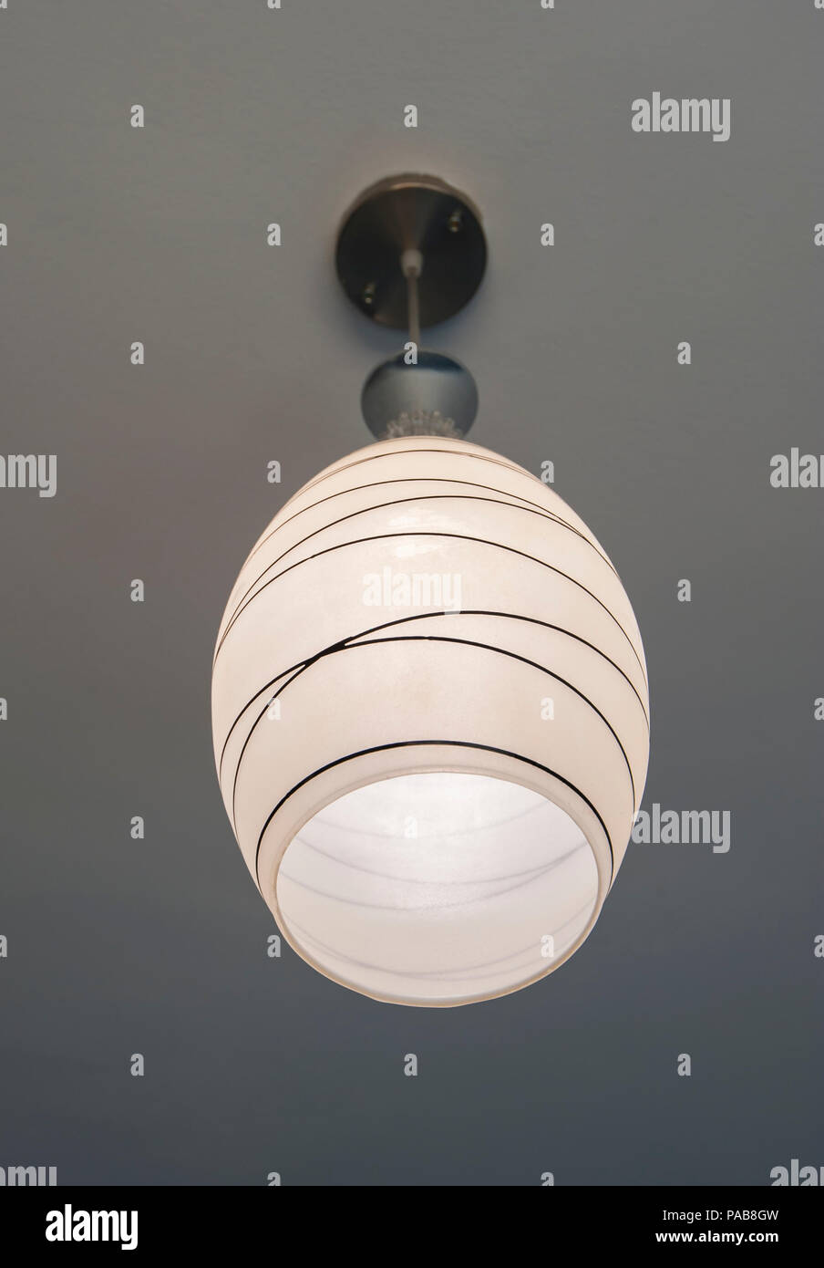Closeup of hanging electric ceiling light with striped lamp shade Stock ...