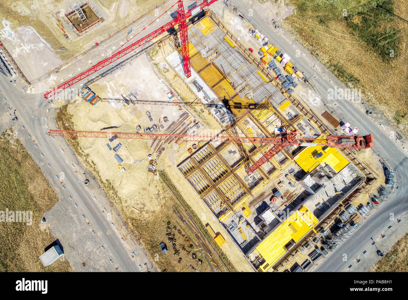 Aerial view from a greater height above the cranes of a construction ...