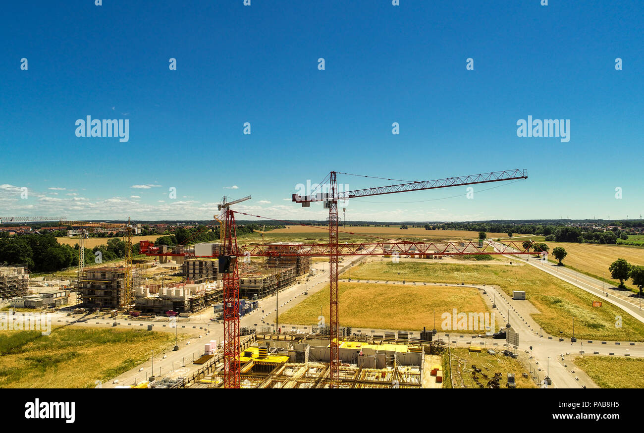 Construction site with cranes and the shells for new houses, in the ...