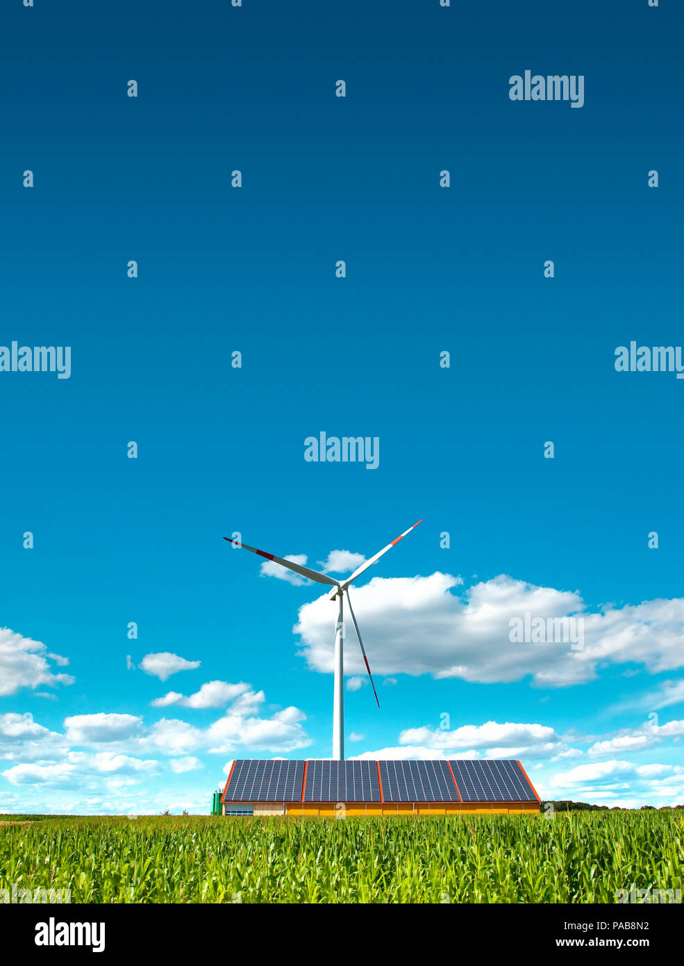A photography of a wind mill and solar panels Stock Photo - Alamy