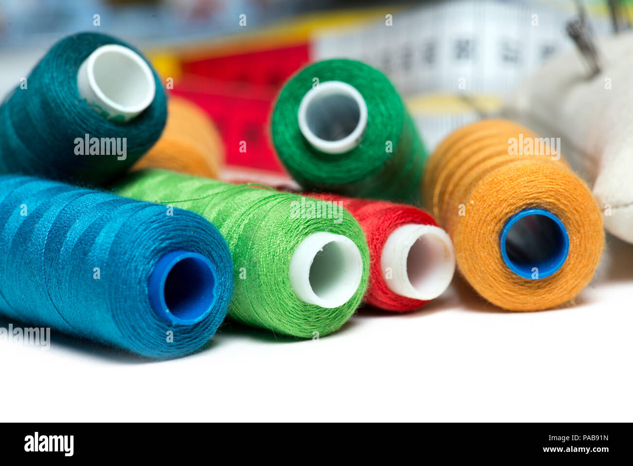 Sewing background with color threads and meter Stock Photo - Alamy