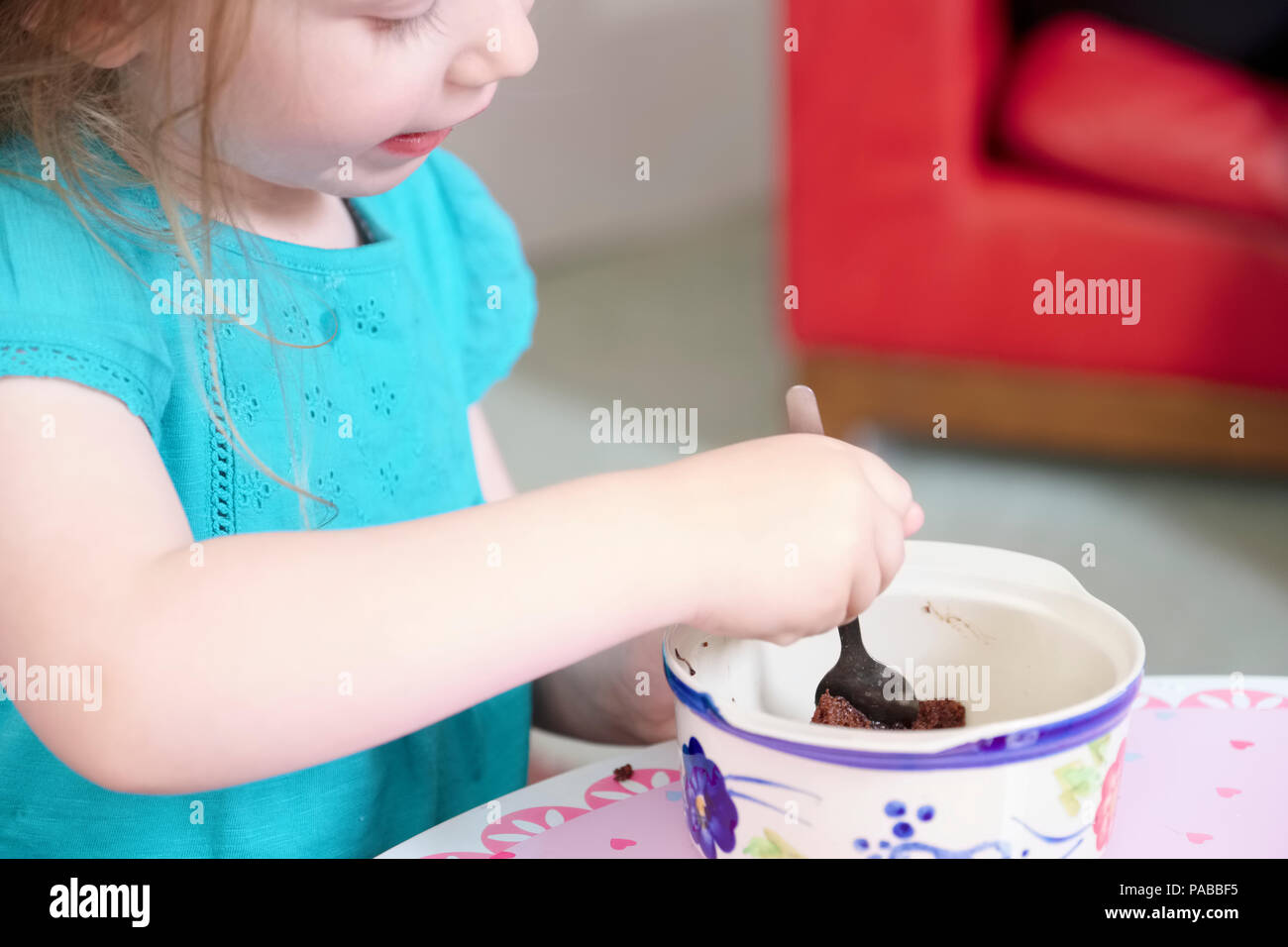 Child eating sweets pudding desert chocolate cake young kid girl with ...