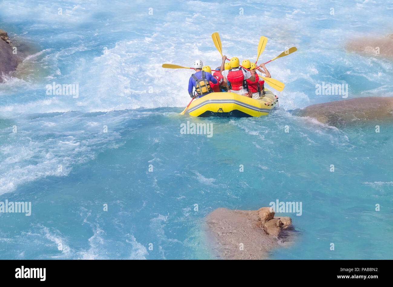 A group of people is rafting in a fast moving river Stock Photo - Alamy