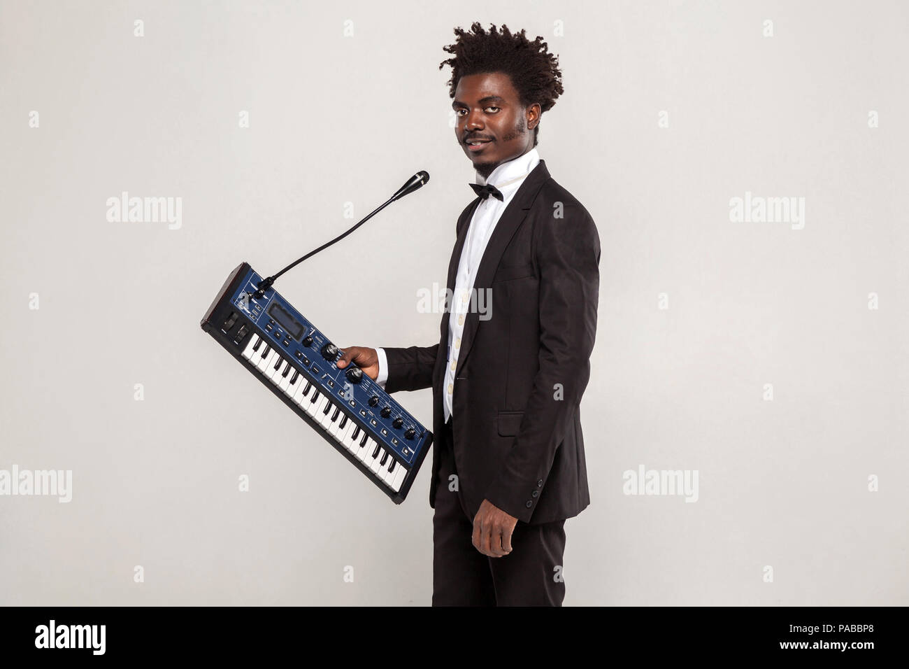 Fashionable african singer with afro hair style in black classic style ...
