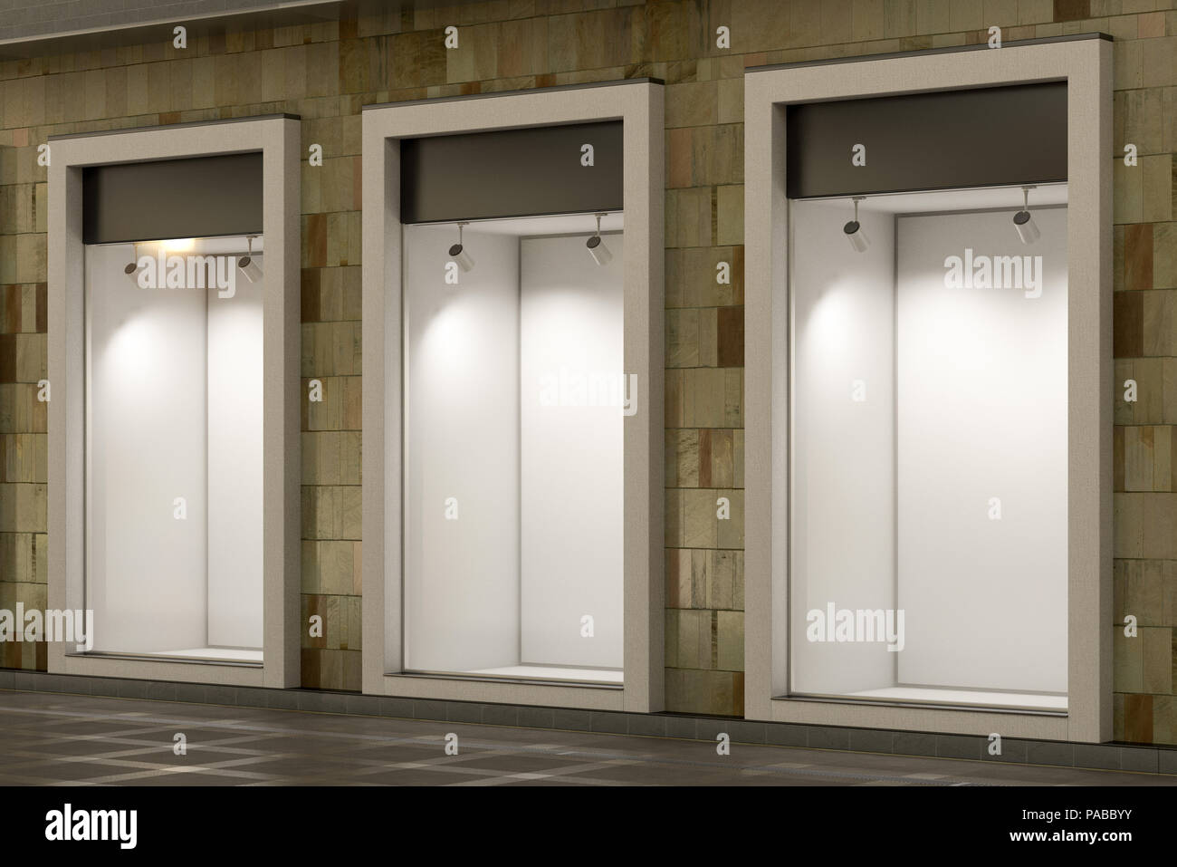 Empty store windows at night. Three blank illuminated storefront ...