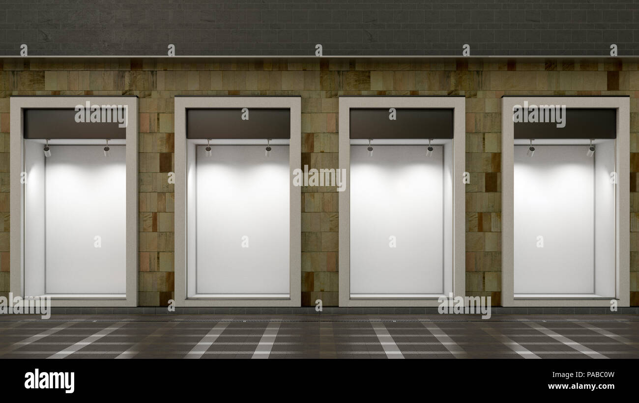 Empty store windows at night. Four blank illuminated storefront ...