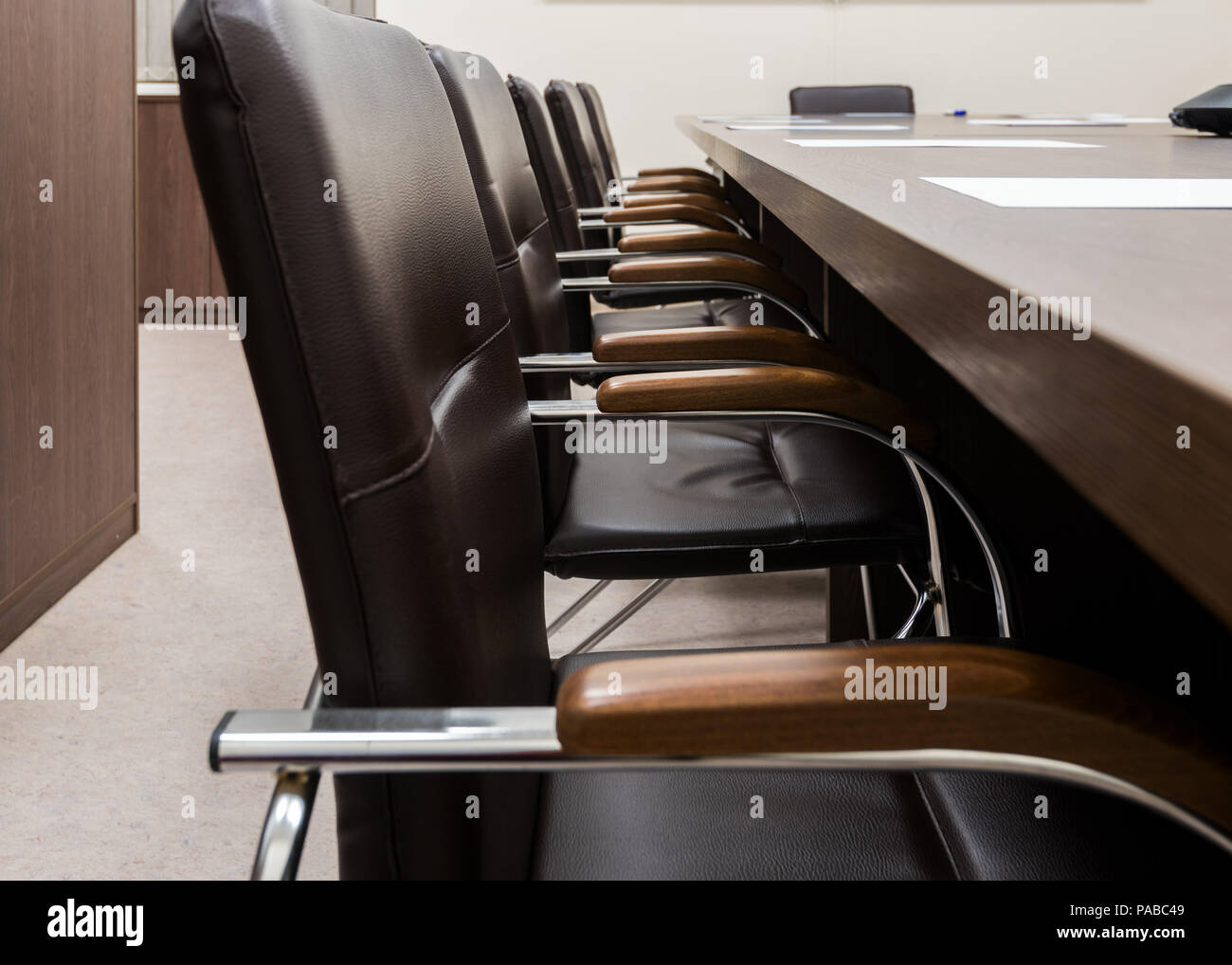 Modern leather chairs with wooden handles Stock Photo - Alamy