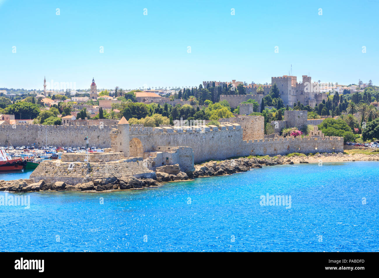 Cityscape of old town Rhodes: Naillac tower in front, palace of grand ...