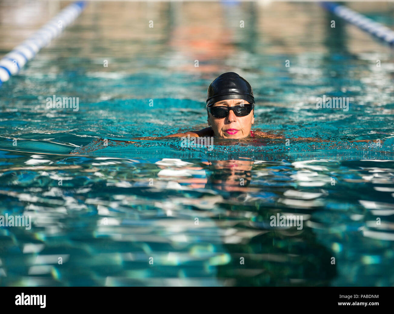 Woman swimming in a pool Stock Photo - Alamy