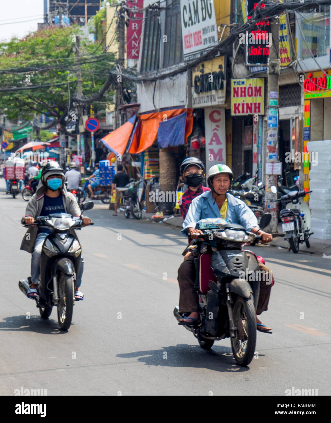 Vietnamese motorcyclists riding motorcycles on the street inHo Chi Minh ...