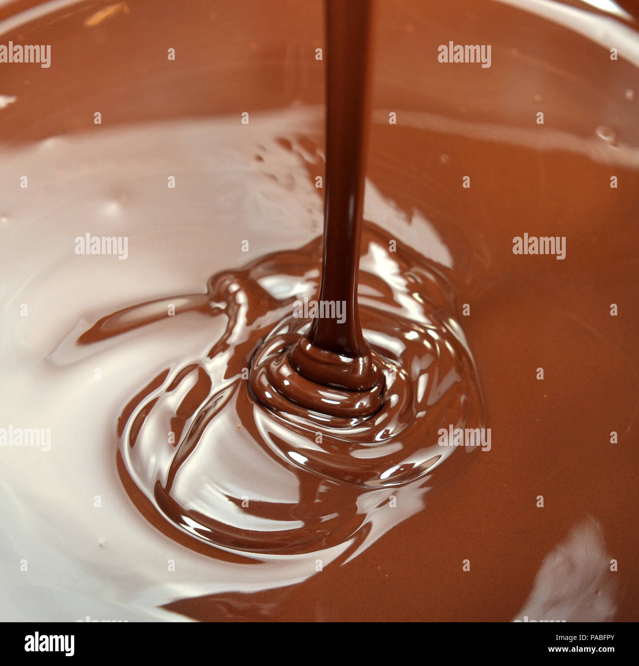 Melted chocolate pouring from cooking hi-res stock photography and ...