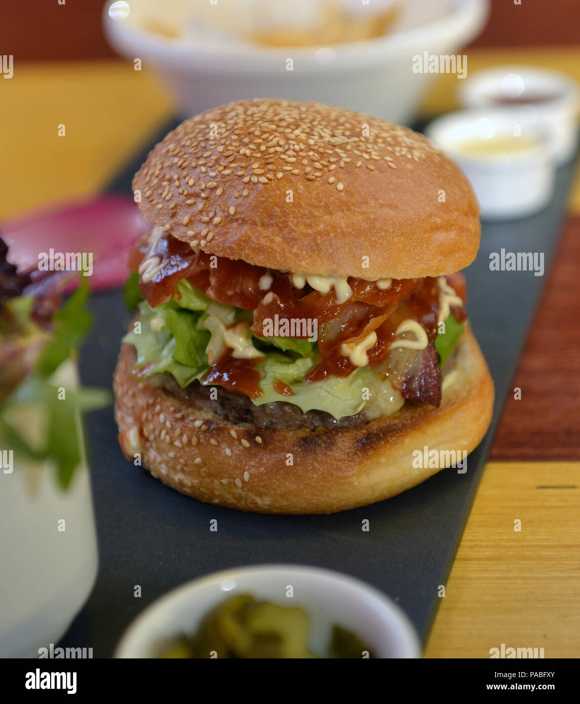burger with lettuce leaves with sauces Stock Photo - Alamy