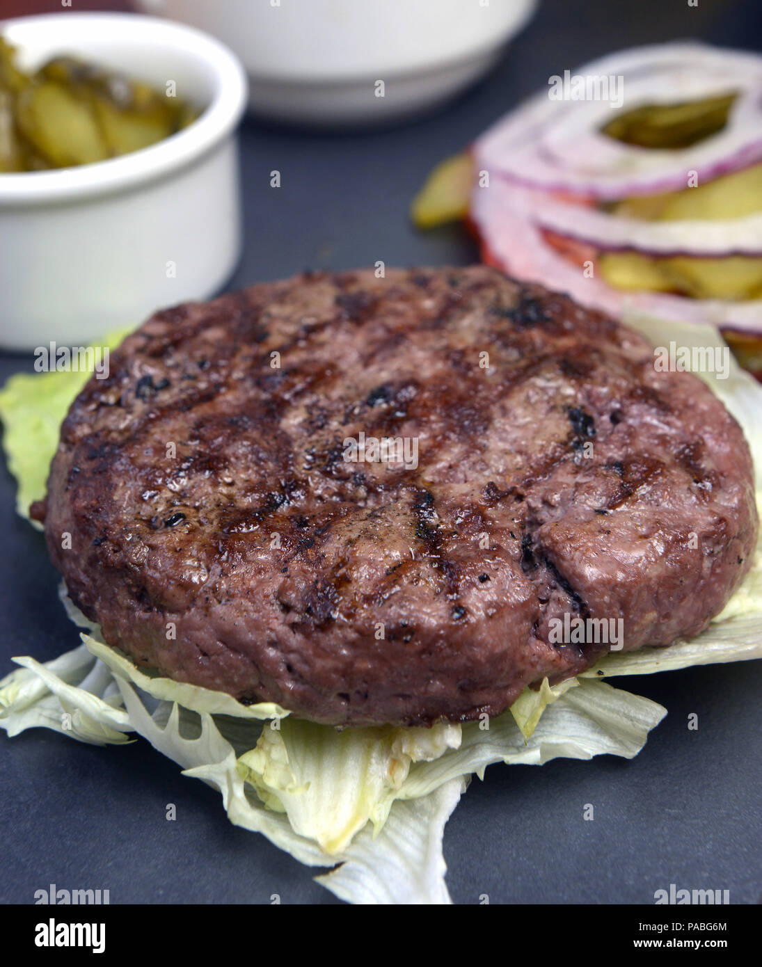 Open burger with lettuce leaves with sauces Stock Photo - Alamy