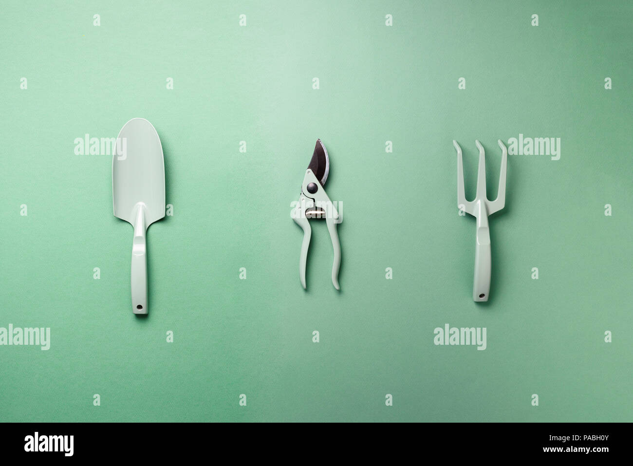 Gardening tools and utensils on green background. Top view with copy ...