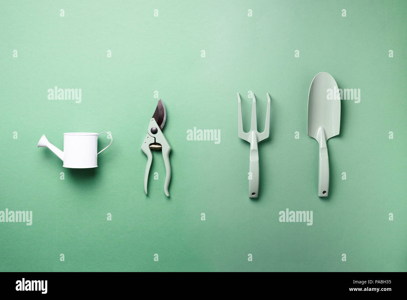 Gardening tools and utensils on green background. Top view with copy ...