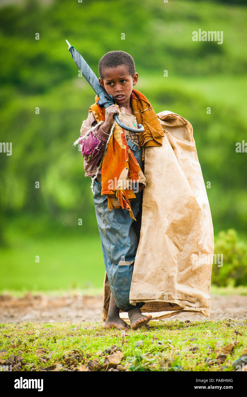 AKSUM, ETHIOPIA - SEPTEMBER 22, 2011: Unidentified Ethiopian boy walks ...