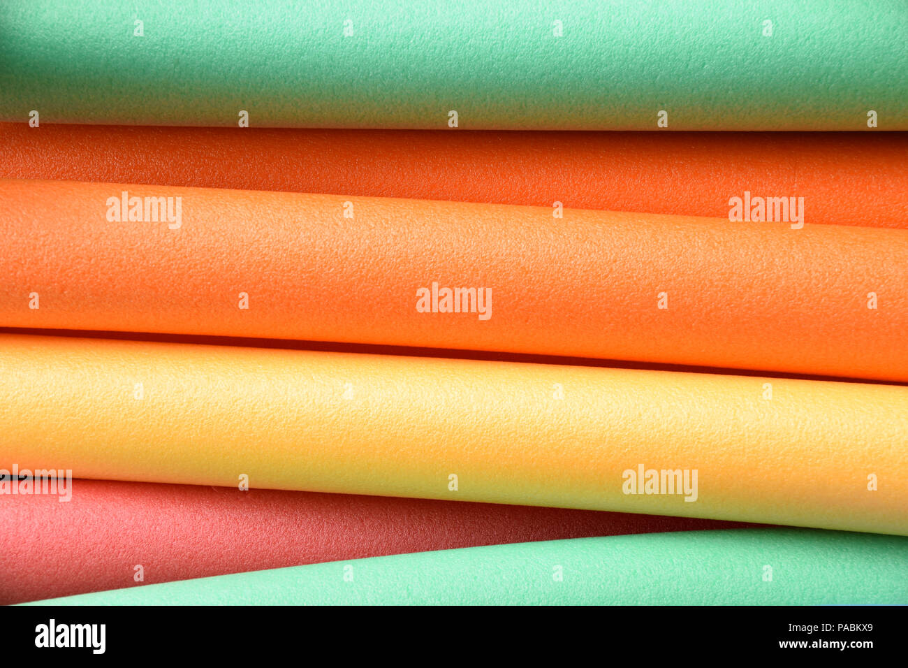 colorful pool noodles in different pastel colors, pool or therapy or ...