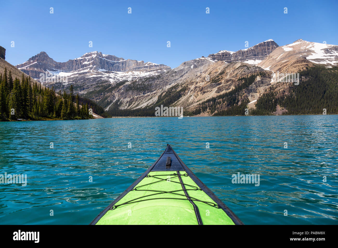 Kayaking in a glacier lake during a vibrant sunny summer day. Taken in ...