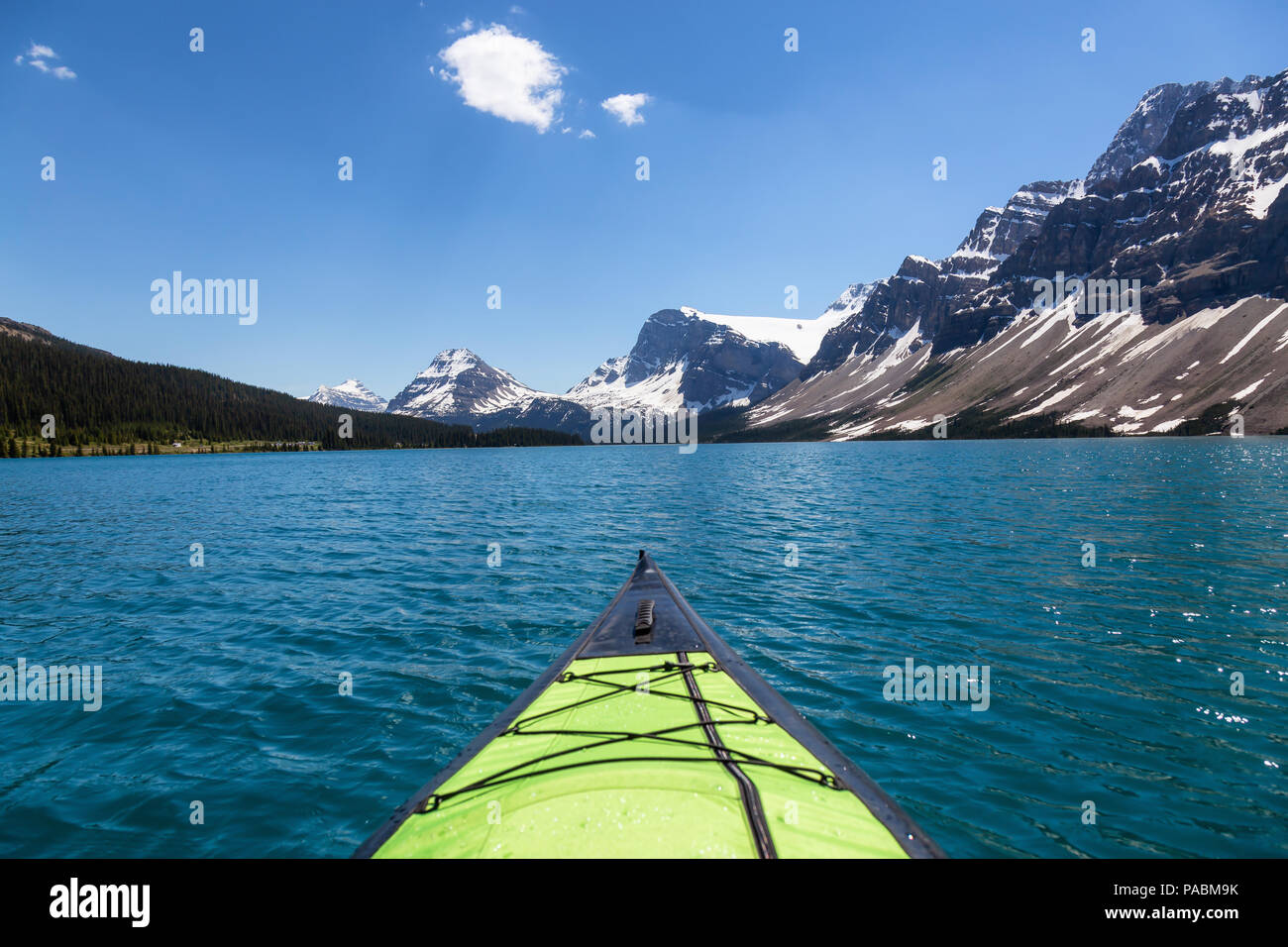 Kayaking in a glacier lake during a vibrant sunny summer day. Taken in ...