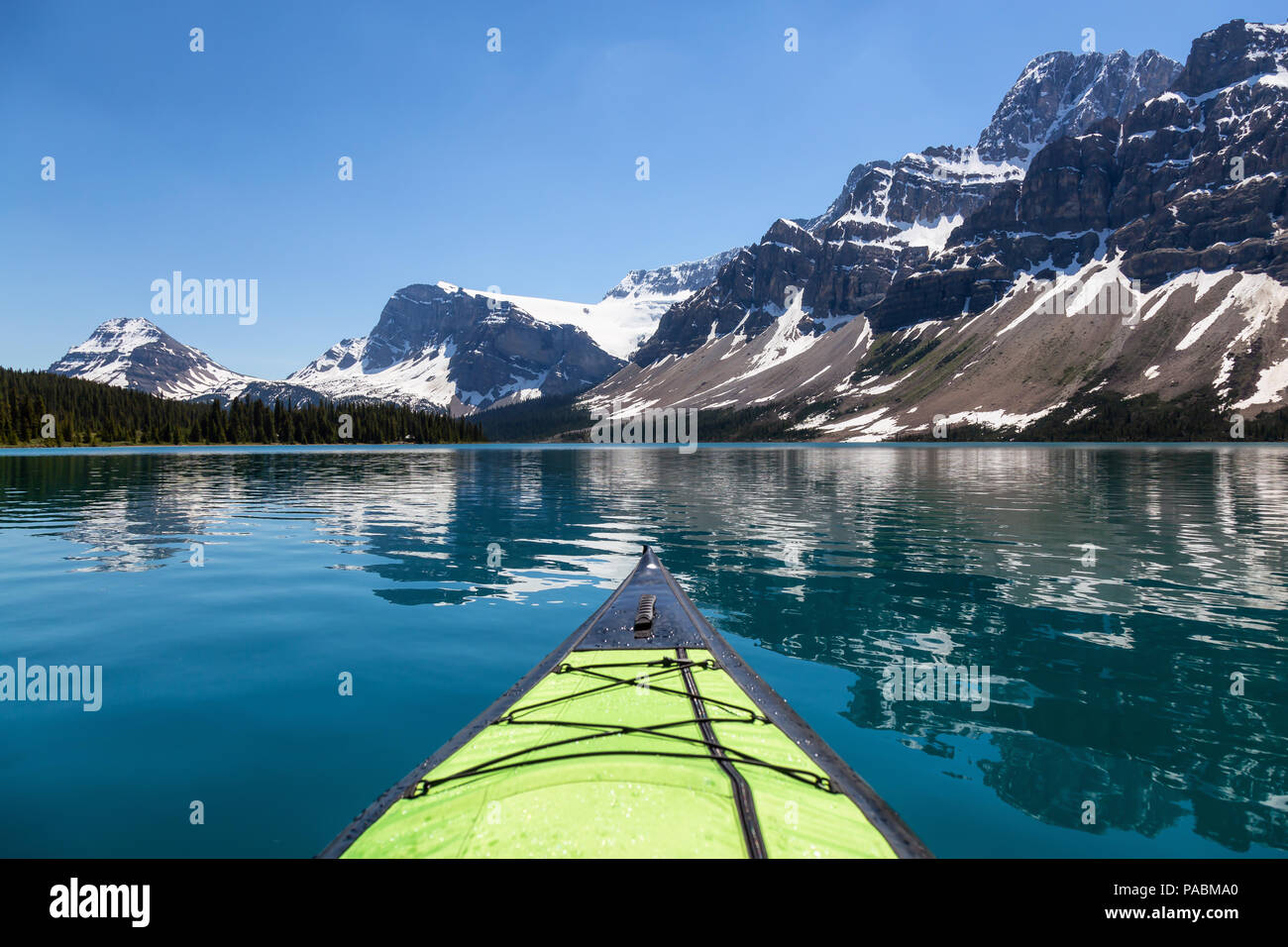 Kayaking in a glacier lake during a vibrant sunny summer day. Taken in ...